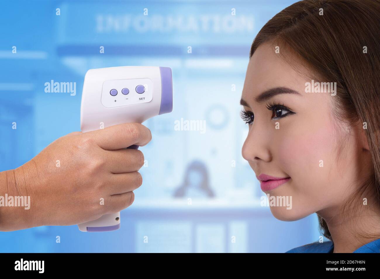 Hand holding digital infrared thermometer to measuring body temperature ...