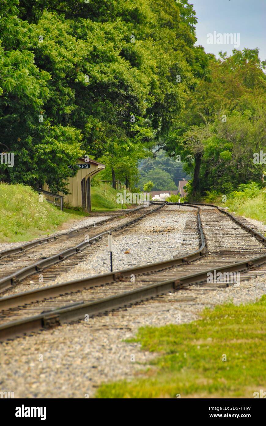 Two Rail Road Tracks on a Lonely small Rail Road Station on a Sunny Day ...