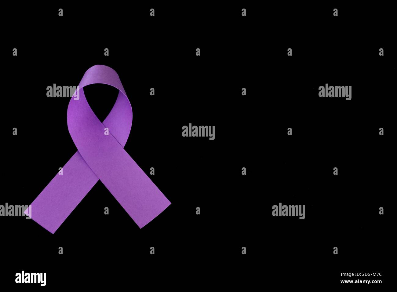 Violet ribbon isolated on the black background Stock Photo - Alamy
