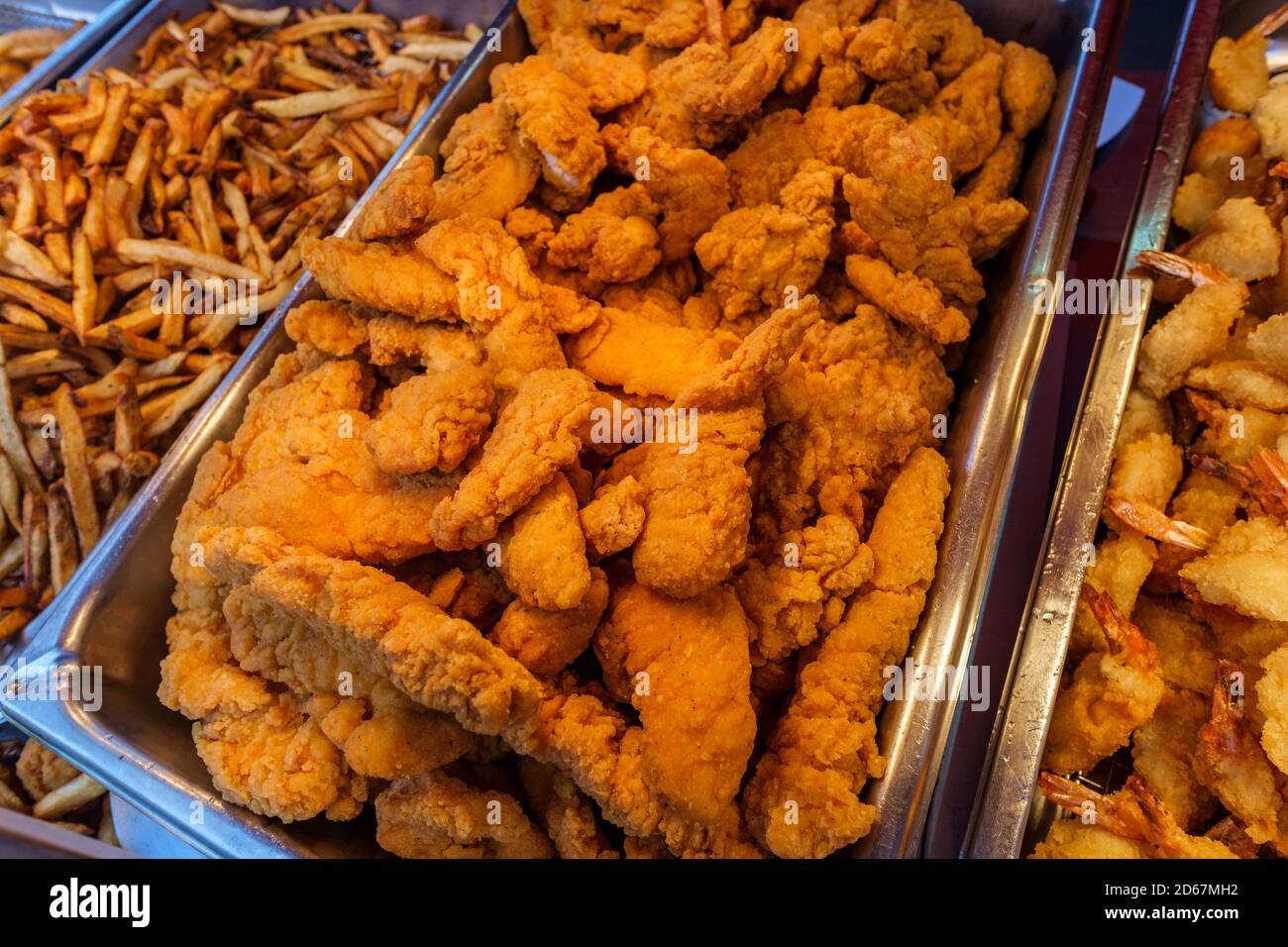 Crispy hot chicken tenders in serving tray at buffet Stock Photo - Alamy