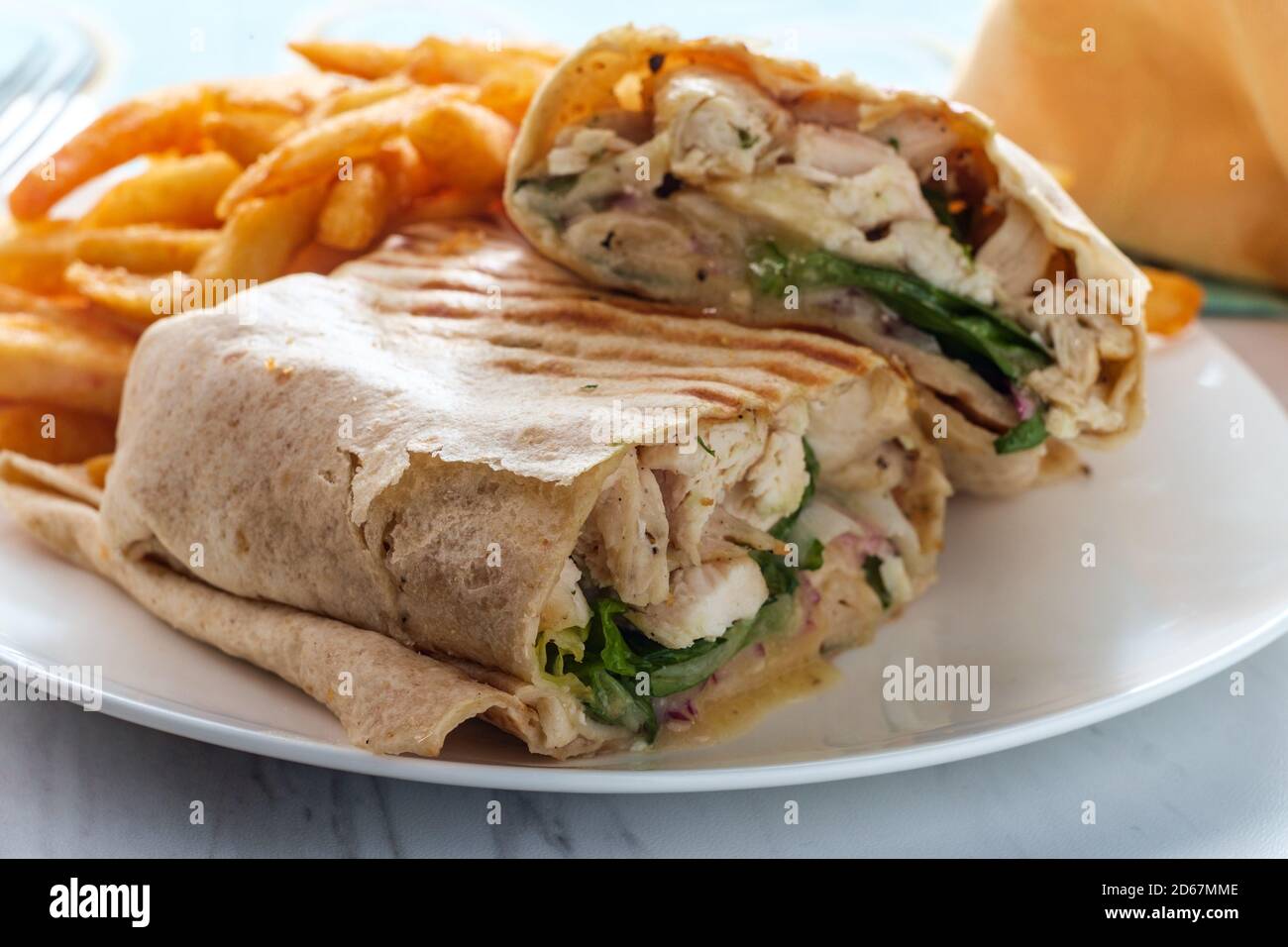 Chicken Caesar salad wrap sandwich with romaine lettuce and french ...