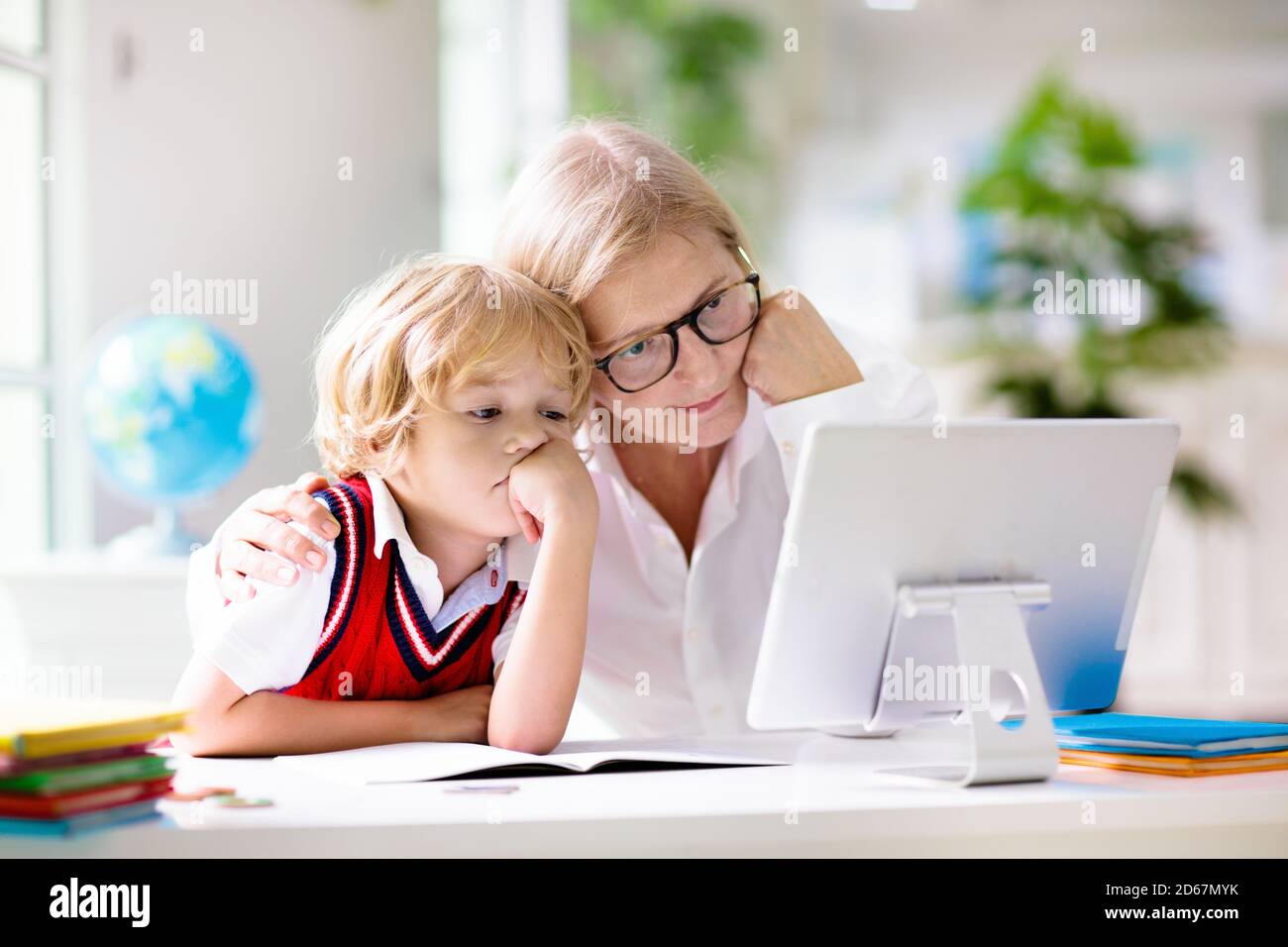 Online remote learning. School kids with computer having video ...