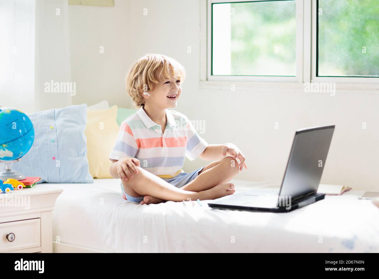 Online remote learning. School kid with computer having video ...