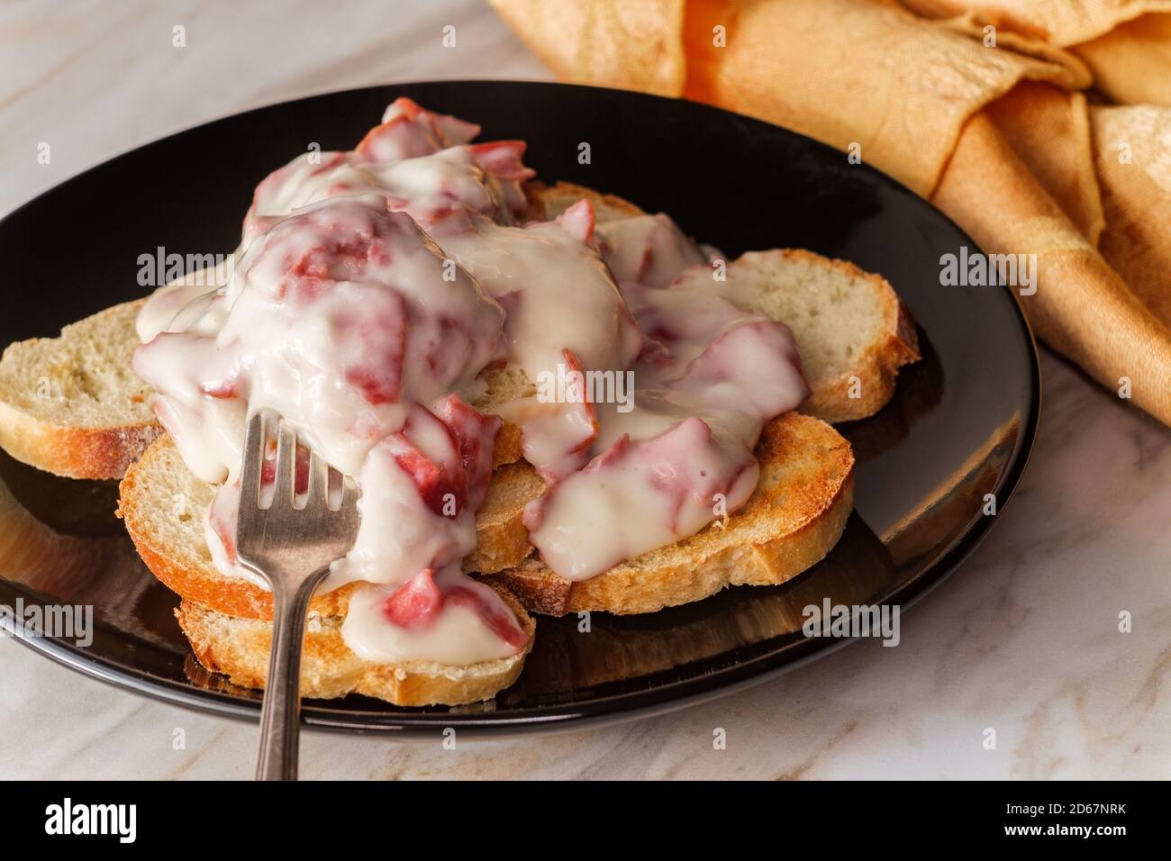Creamed and chipped beef on sliced toast on marble kitchen table also ...
