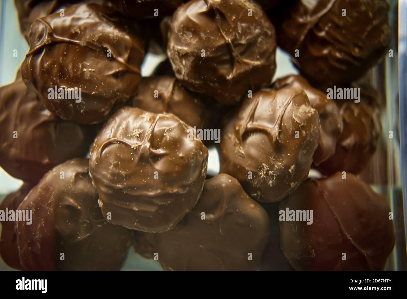 Rows of delicious chocolate candies in display case for sale Stock ...