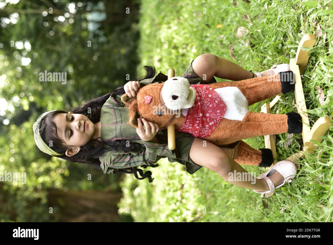 Happy little child and a rocking horse Stock Photo - Alamy
