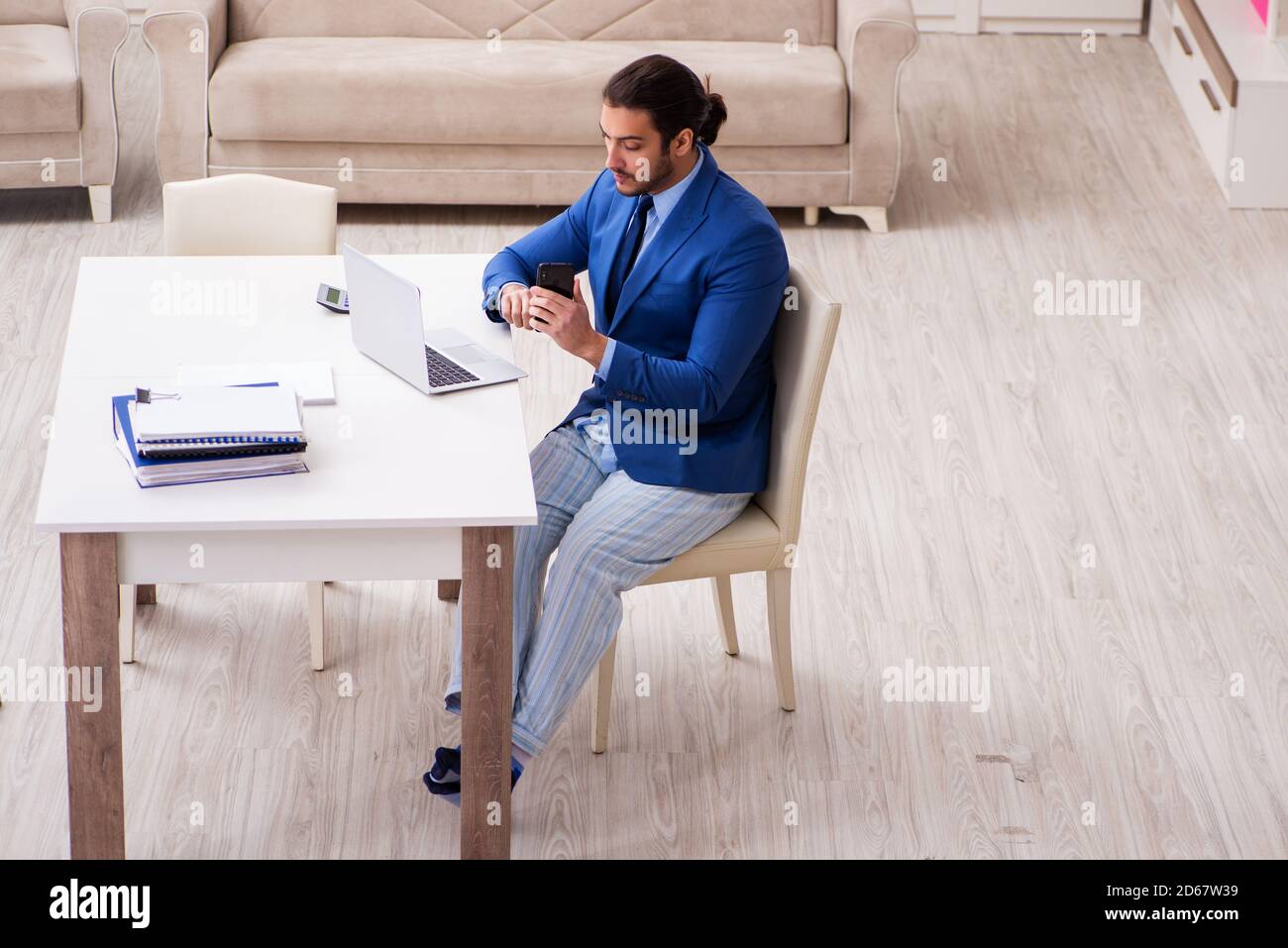 Young employee working from house in self-isolation concept Stock Photo ...