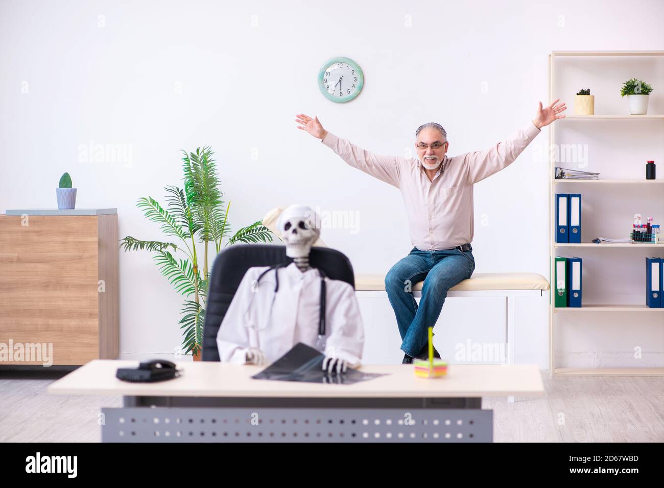 Skeleton doctor in funny medical concept Stock Photo - Alamy