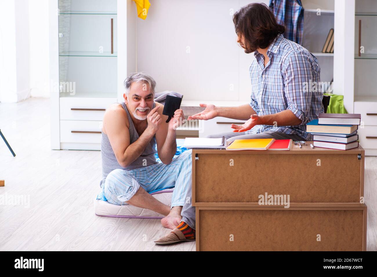Young son student and dad alcoholic at home Stock Photo - Alamy
