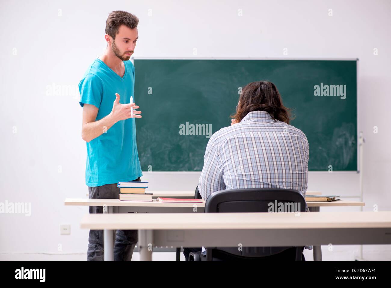 Male pupils in bullying concept in the classroom Stock Photo - Alamy
