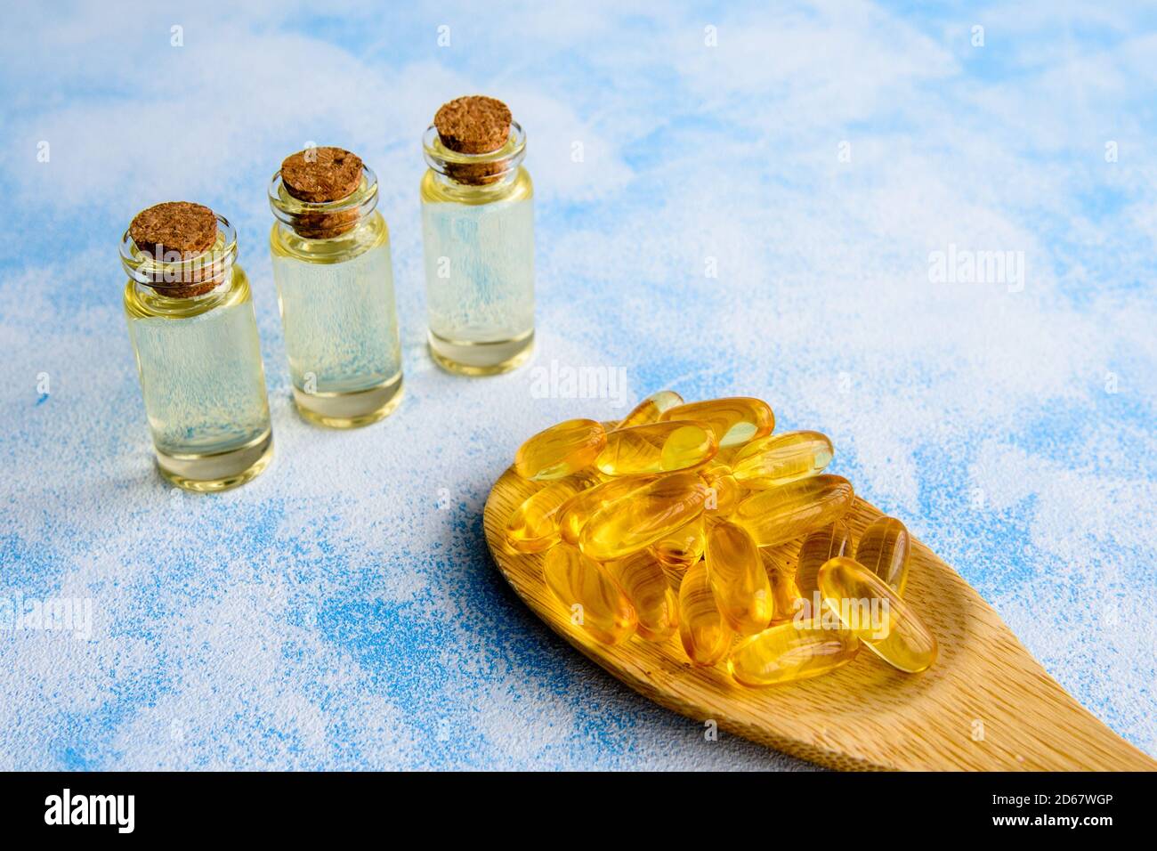 Fish oil capsules on a blue background - omega 3 vitamins and health ...