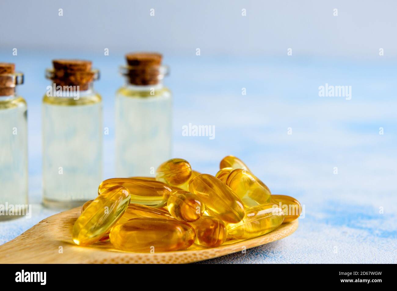 Fish oil capsules on a blue background - omega 3 vitamins and health ...