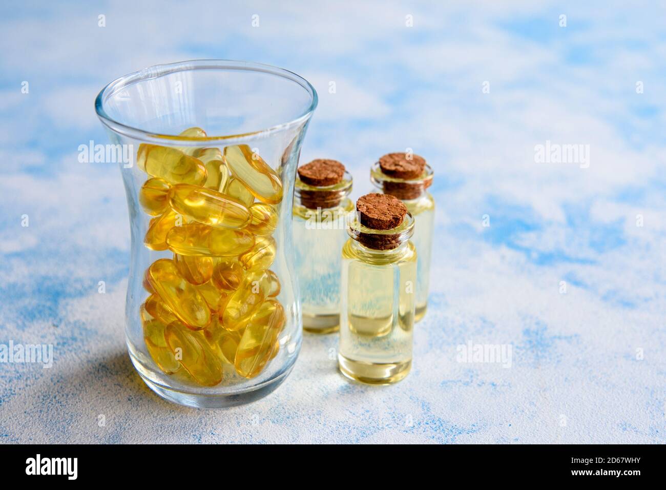 Fish oil capsules blue table hi-res stock photography and images - Alamy