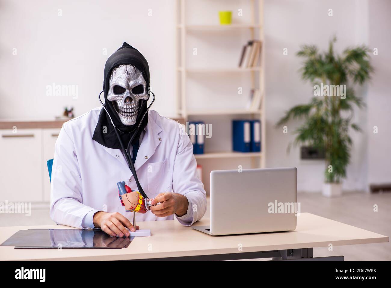 Male devil doctor working in clinic Stock Photo - Alamy