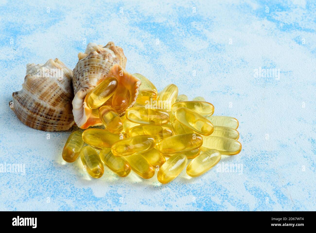 Fish oil capsules blue table hi-res stock photography and images - Alamy