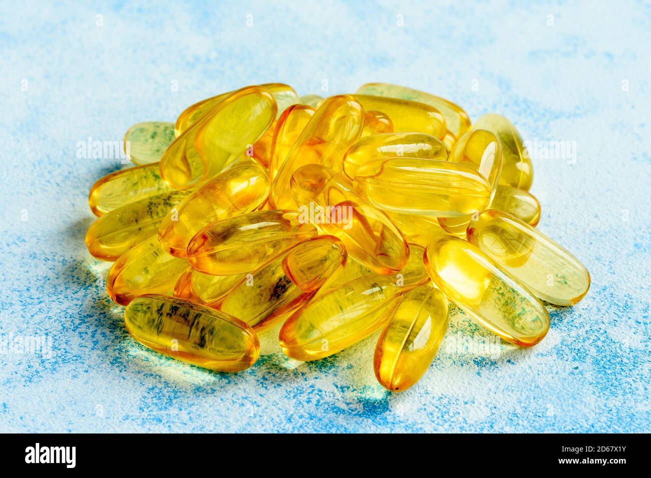 Fish oil capsules on a blue background - omega 3 vitamins and health ...