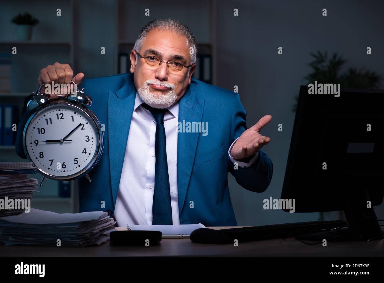 Old employee working late in the office Stock Photo - Alamy