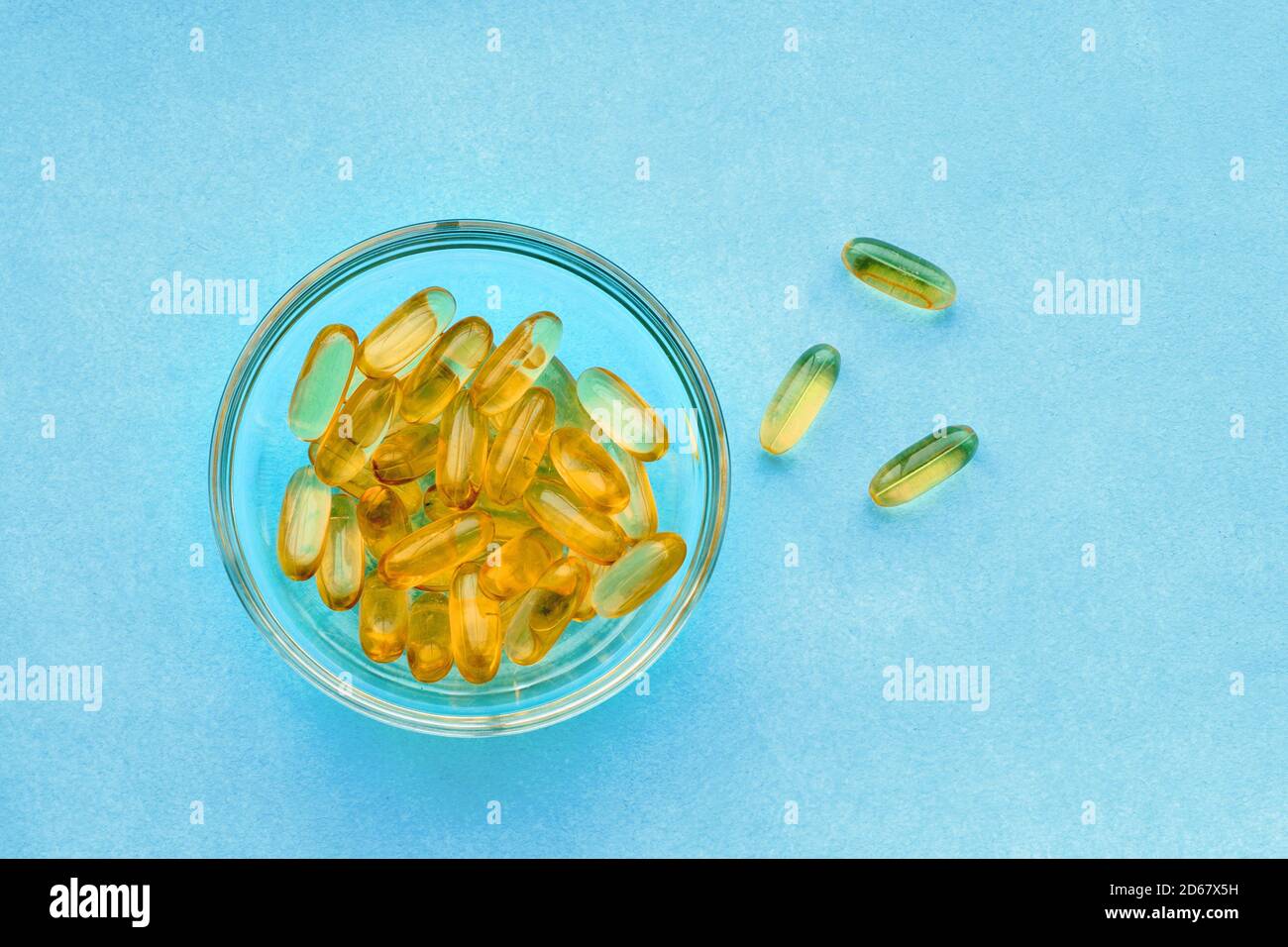 Fish oil capsules blue table hi-res stock photography and images - Alamy
