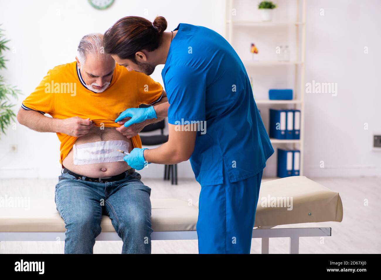 Old man visiting male doctor Stock Photo - Alamy