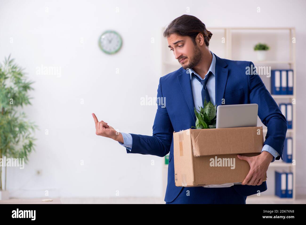 Young man being fired from his workplace Stock Photo - Alamy