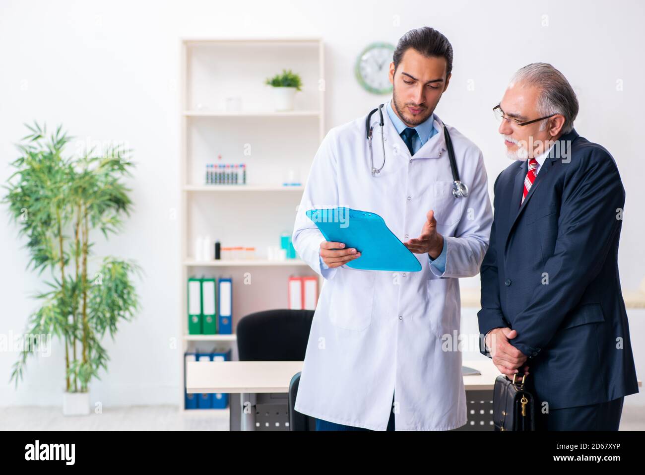 Doctor and businessman discussing medical project Stock Photo - Alamy