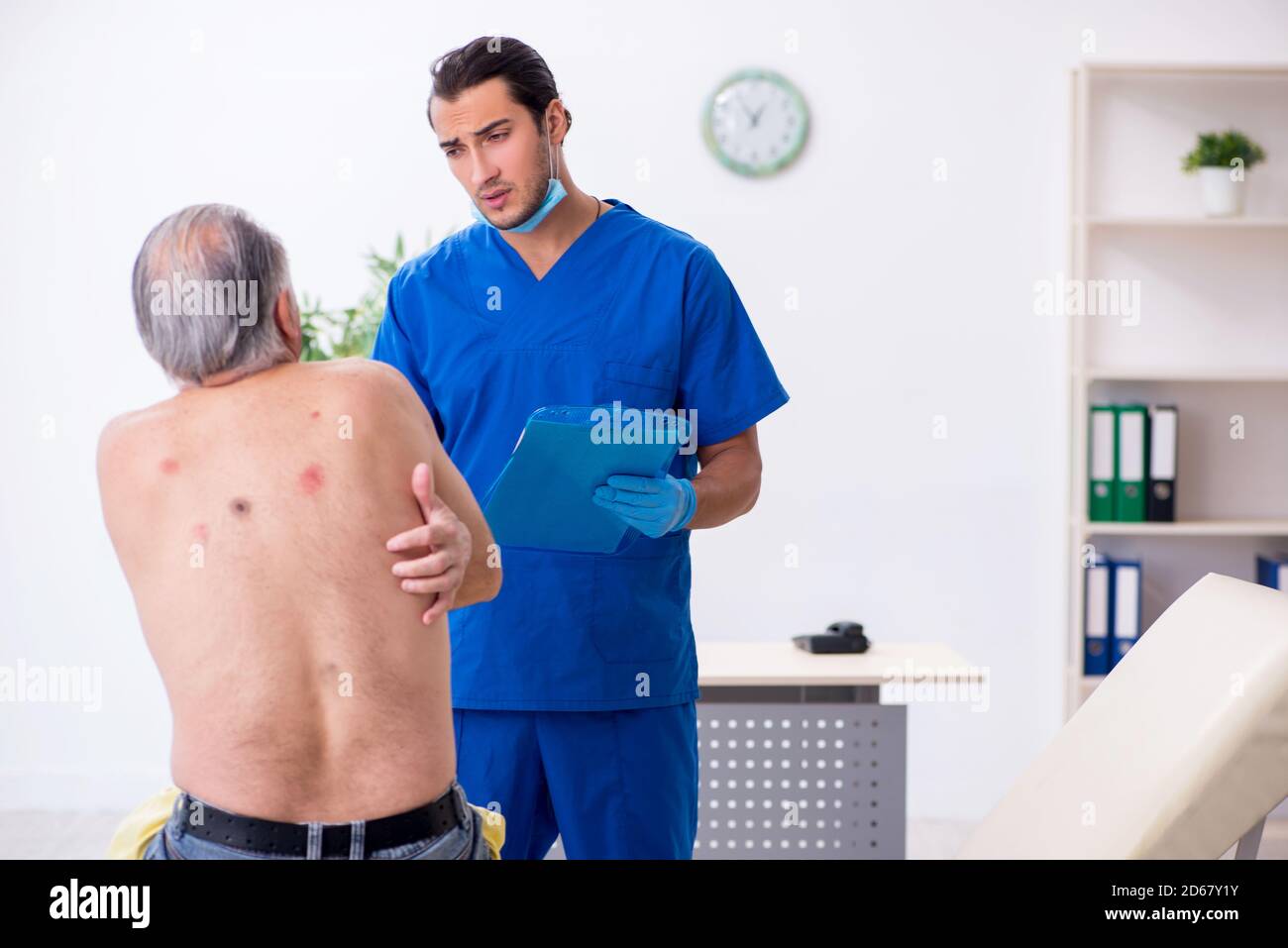 Old man visiting male doctor dermatologist Stock Photo - Alamy