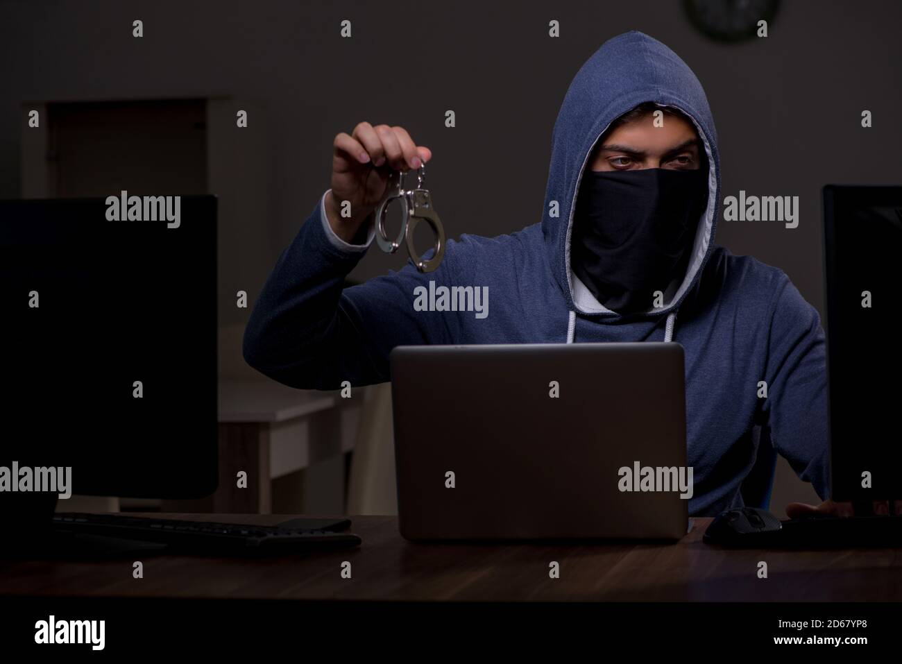 Male hacker hacking security firewall late in the office Stock Photo ...
