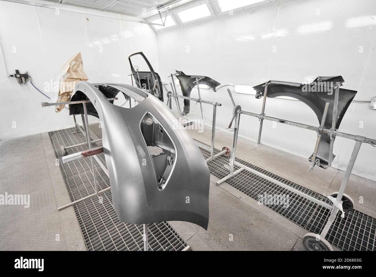 Various parts of the car on the stands for painting. Garage painting ...