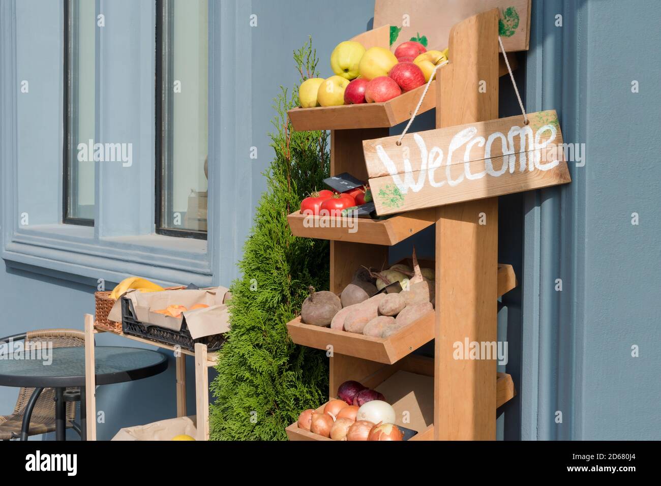 Fresh fruits and vegetables on market counter with welcome signboard ...