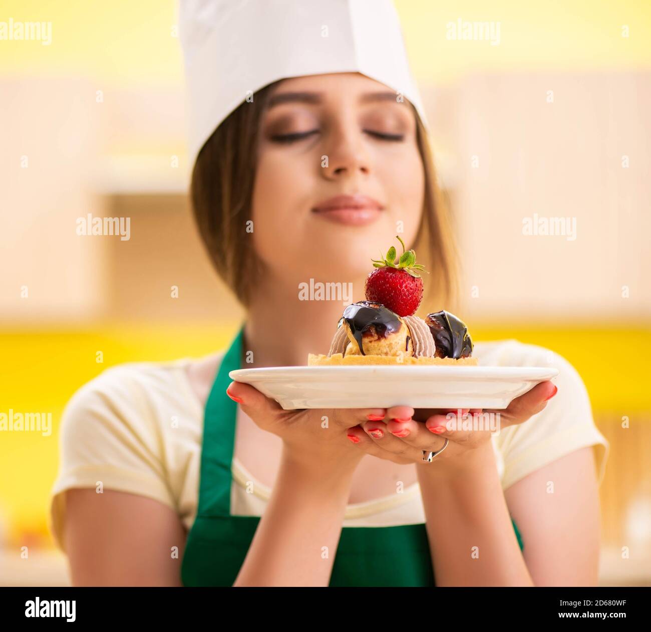 Confectioner in kitchen making strawberry hi-res stock photography and ...