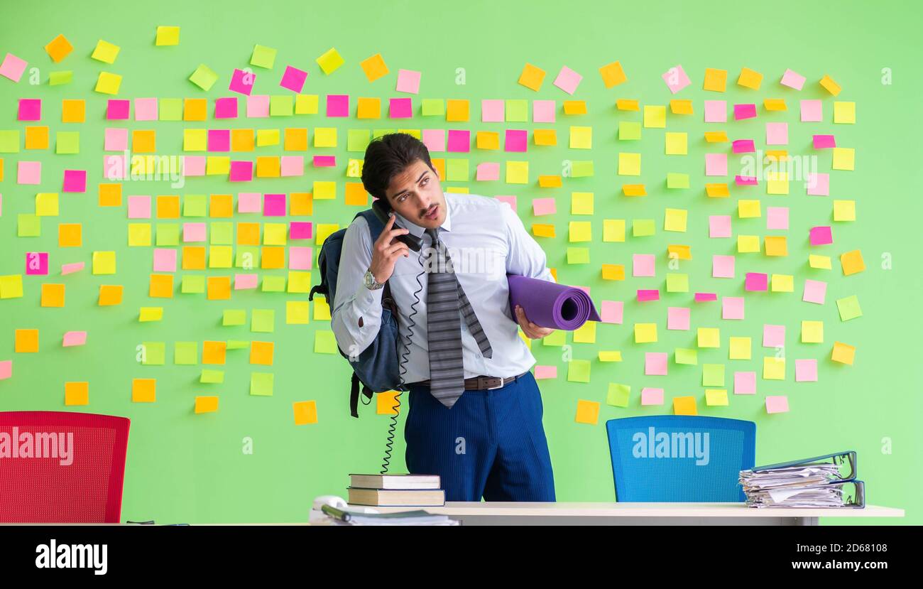 Man in the office with many conflicting priorities preparing go for ...