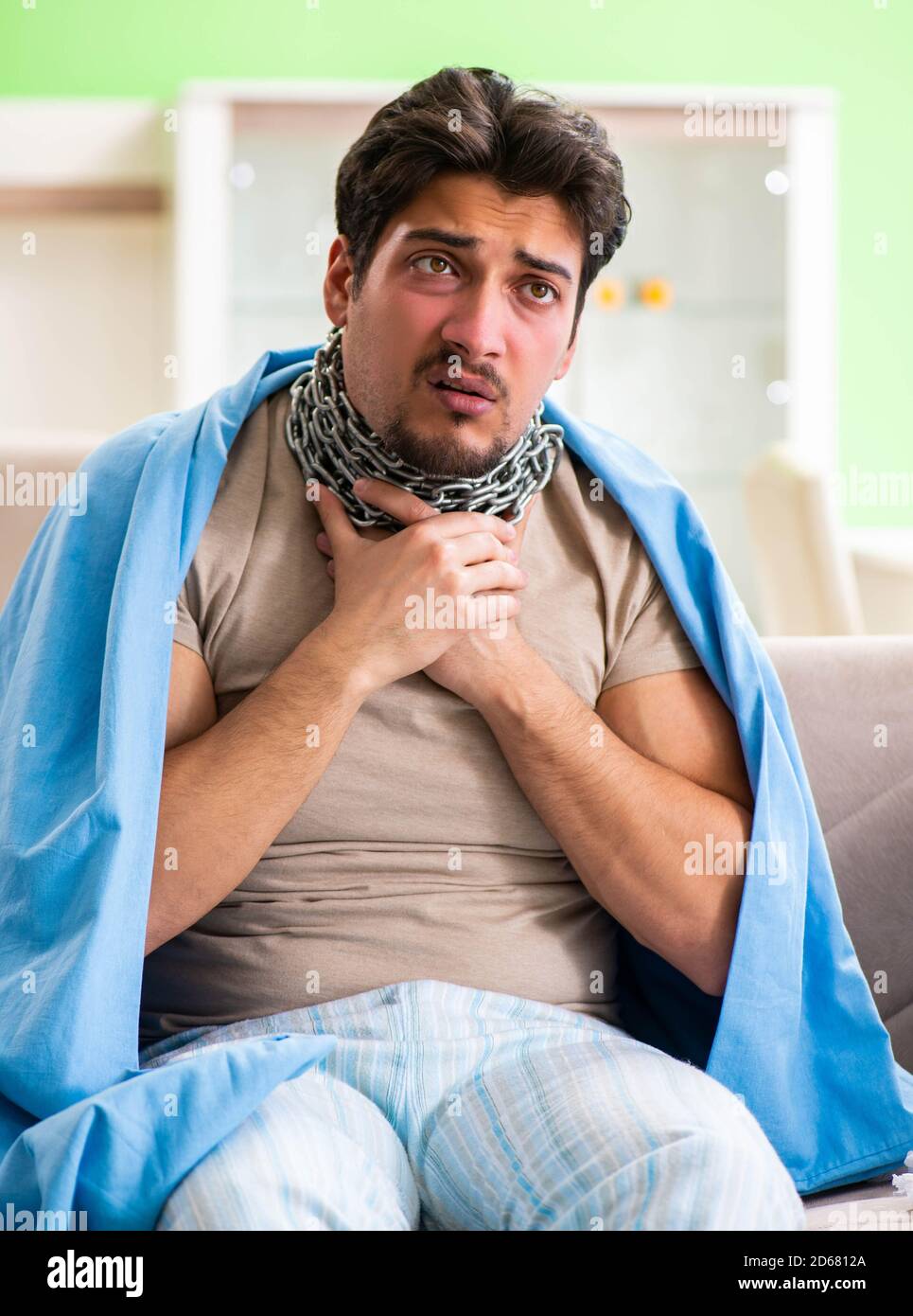 The sick young man suffering from flu at home Stock Photo - Alamy