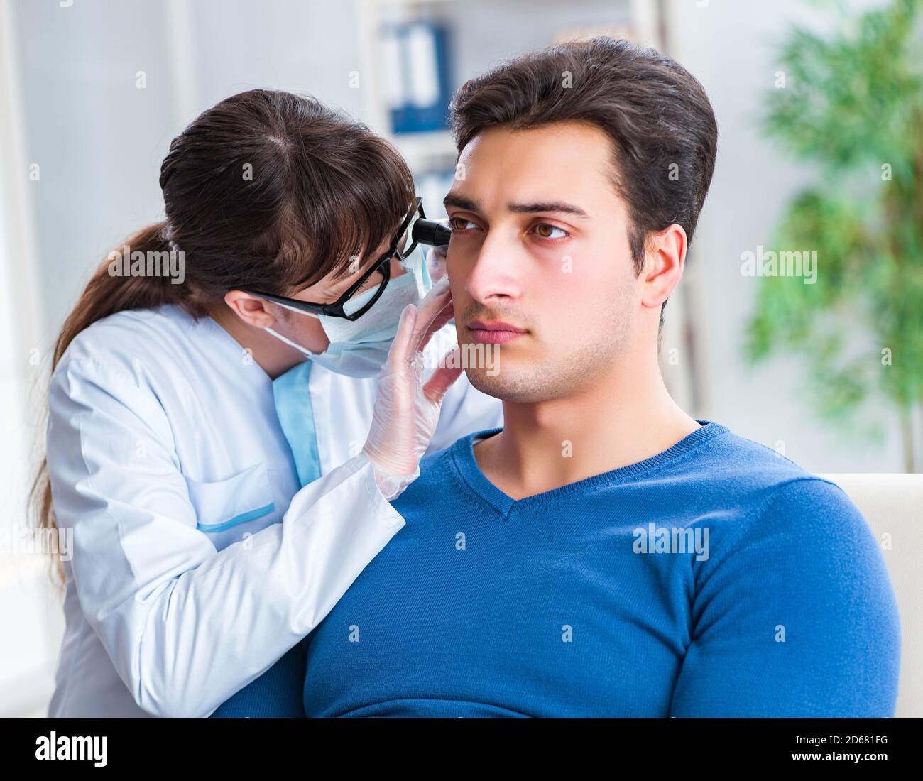 The doctor checking patients ear during medical examination Stock Photo ...