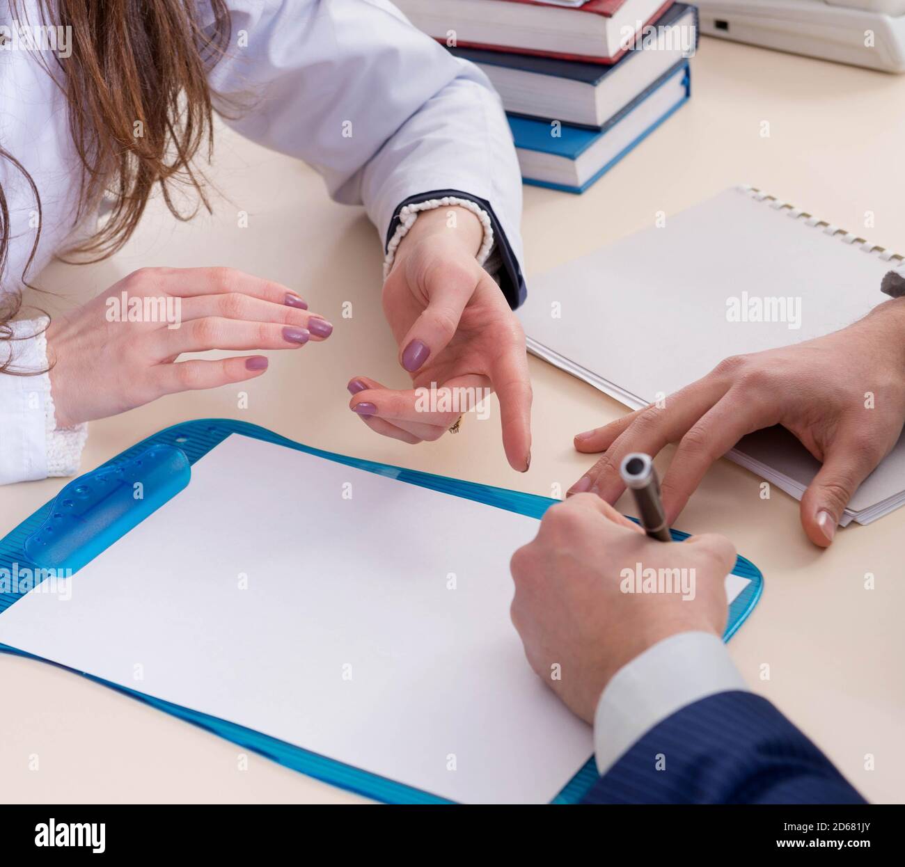 The man signing medical insurance contract Stock Photo - Alamy
