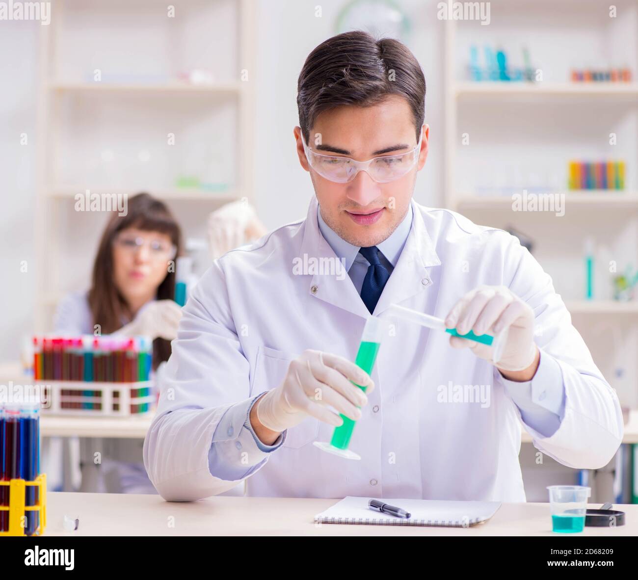 The two chemists working in lab experimenting Stock Photo - Alamy