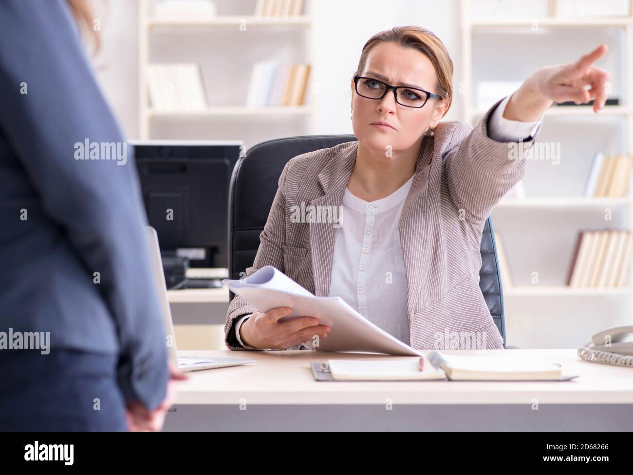 The angry boss dismissing employee for bad underperformance Stock Photo ...