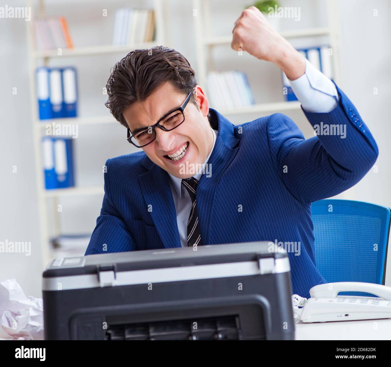 The businessman angry at copying machine jamming papers Stock Photo - Alamy