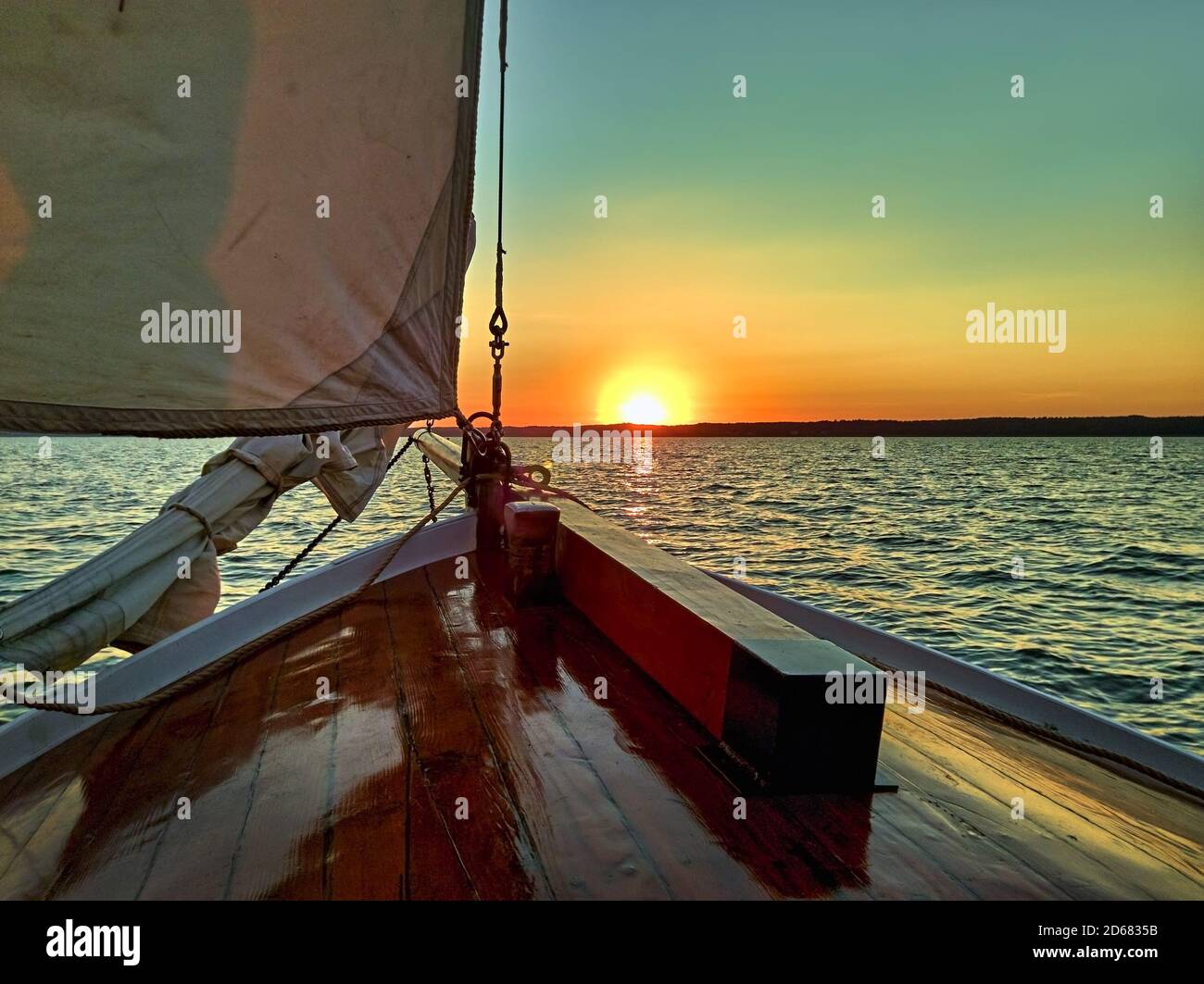 Yacht sailing at beautiful sunset Stock Photo - Alamy