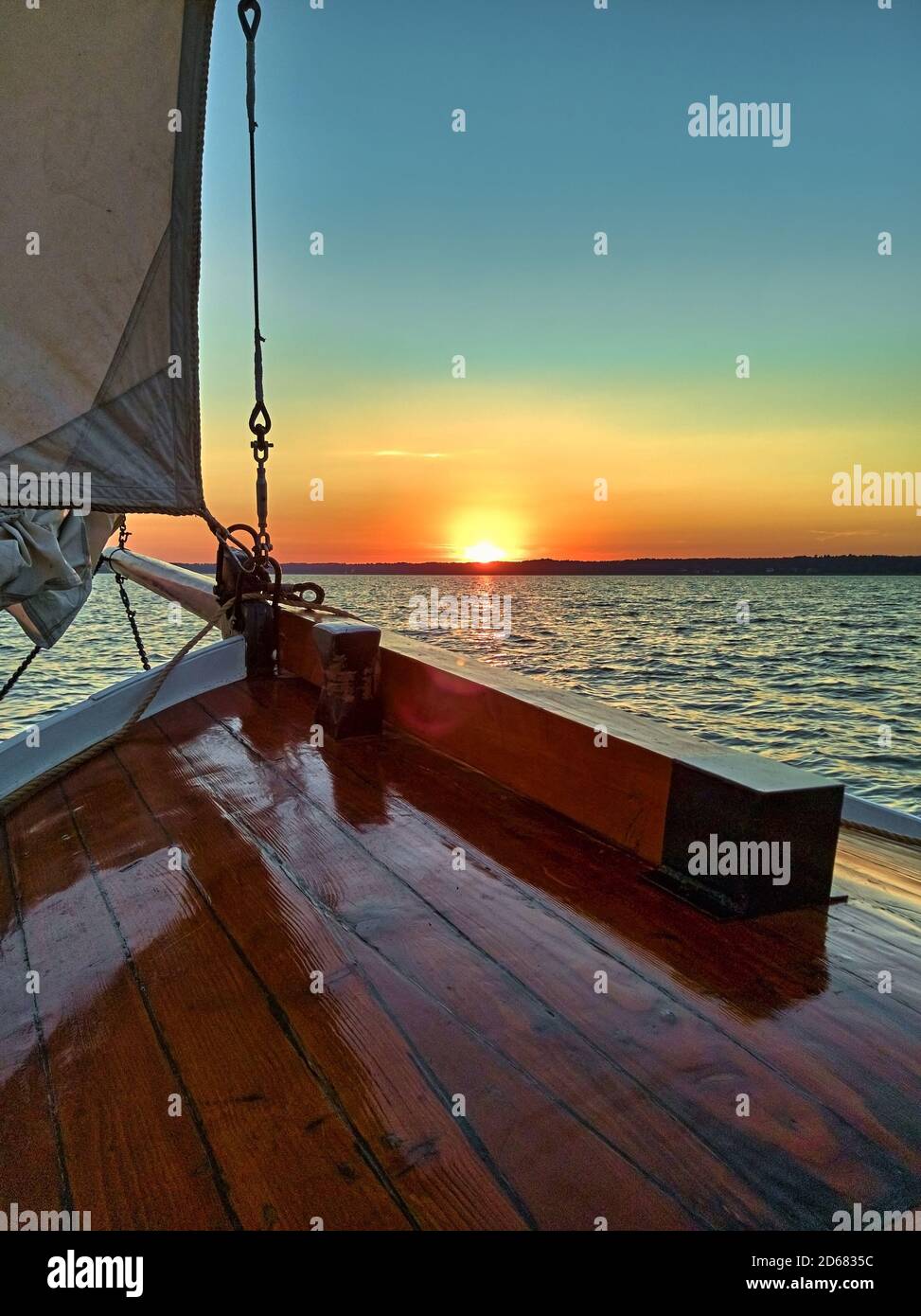 Yacht sailing at beautiful sunset Stock Photo - Alamy