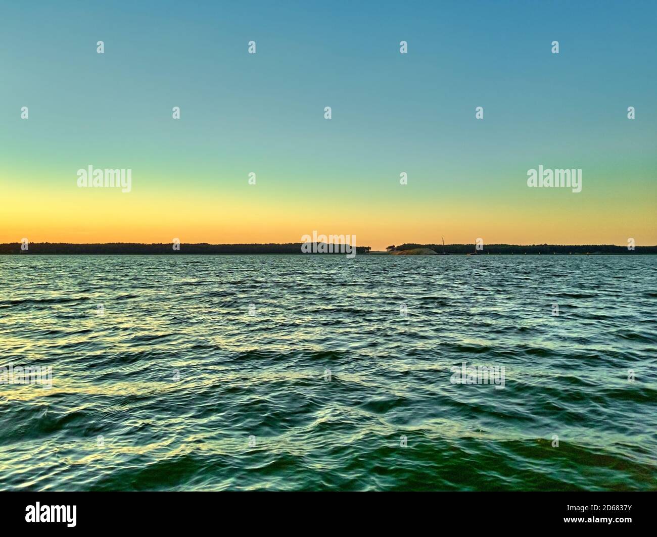 Vistula Spit canal works seen from Vistula Lagoon at sunset Stock Photo ...