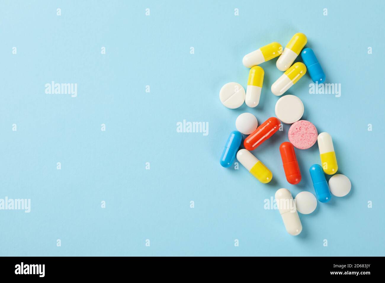 Different pills on blue background, space for text Stock Photo - Alamy