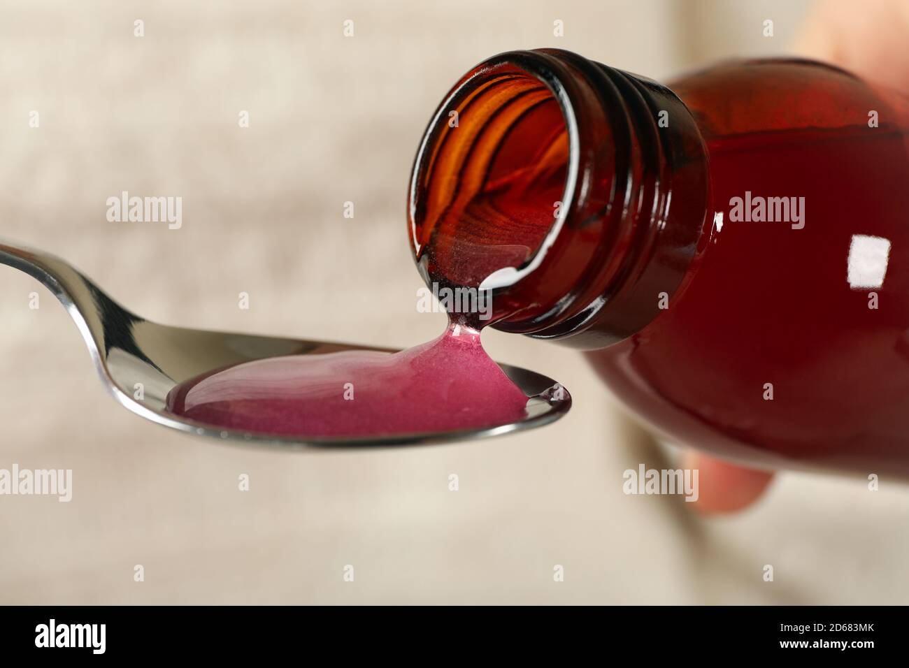 Syrup pouring from bottle to spoon, close up Stock Photo - Alamy