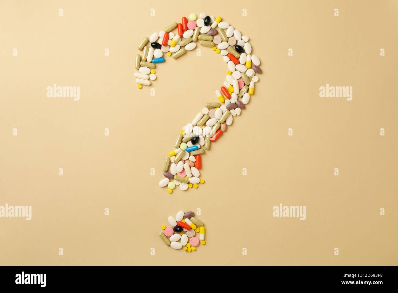 Question mark made of pills on beige background Stock Photo - Alamy