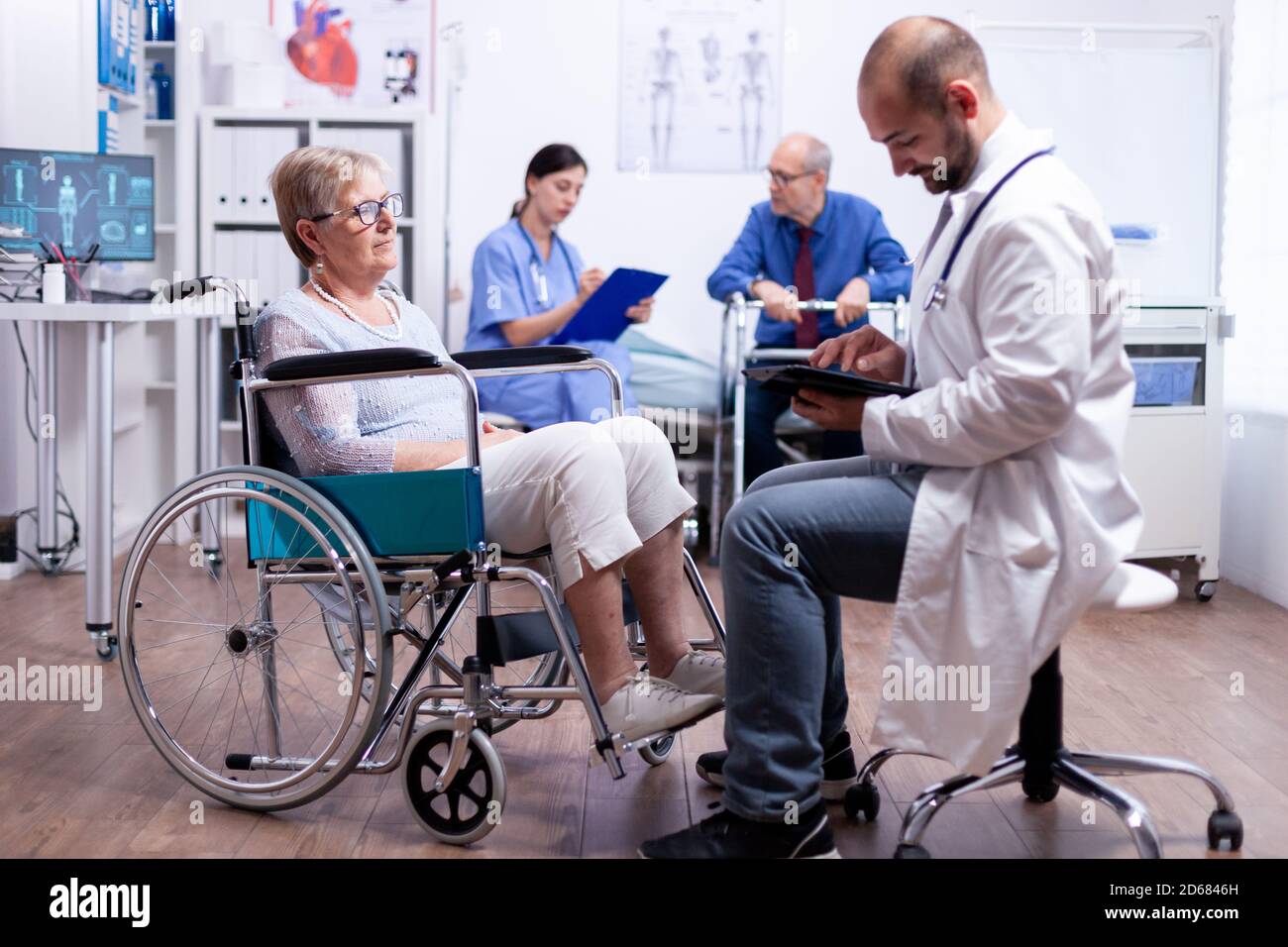 Doctor checking recovery treatment of disabled senior woman in ...