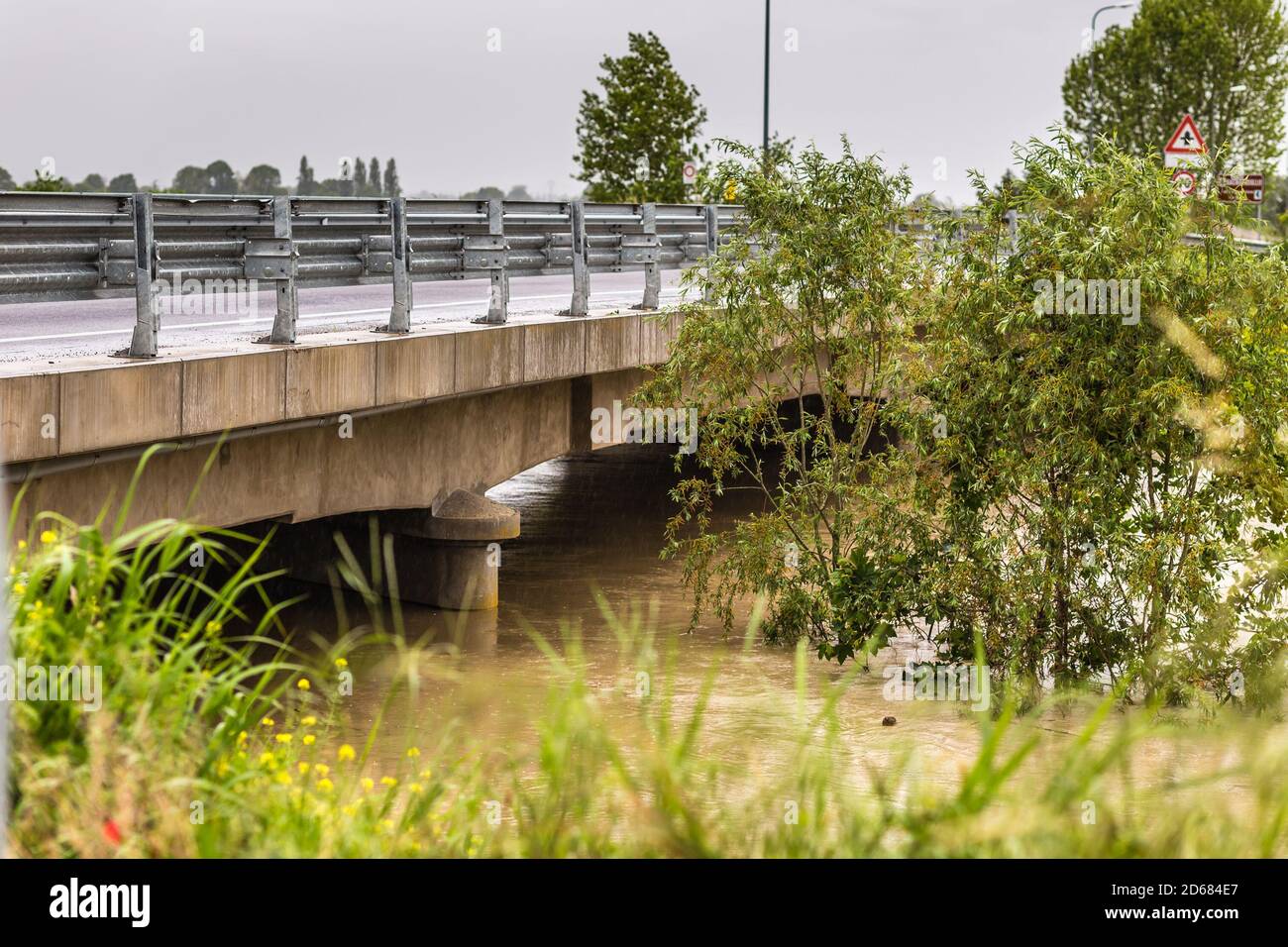 bridge on muddy water of a raging river Stock Photo - Alamy