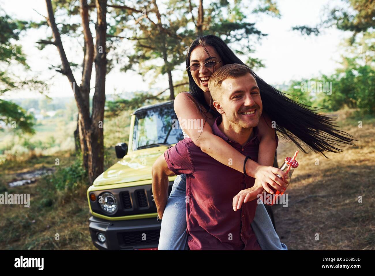 Smiling and having fun. Couple of young people with alcohol have fun in ...
