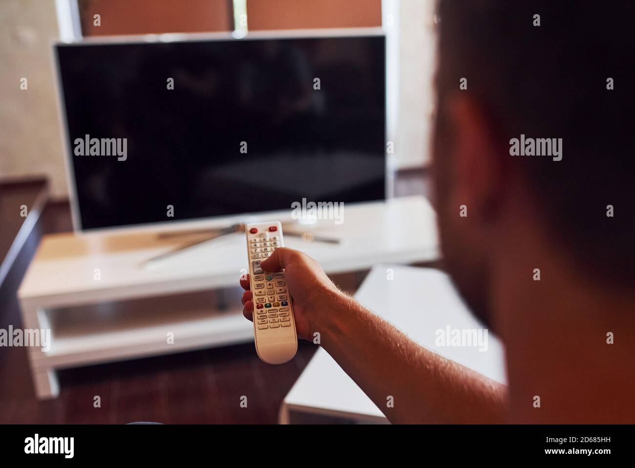 Hand tv remote turning off hi-res stock photography and images - Alamy