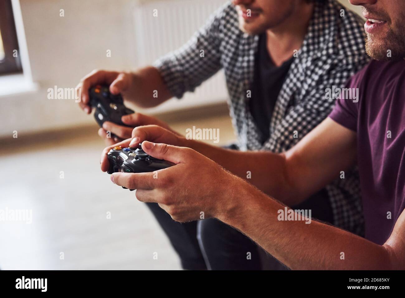 Group of friends have fun playing console game indoors at living room ...