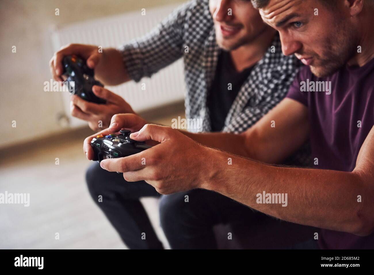 Group of friends have fun playing console game indoors at living room ...