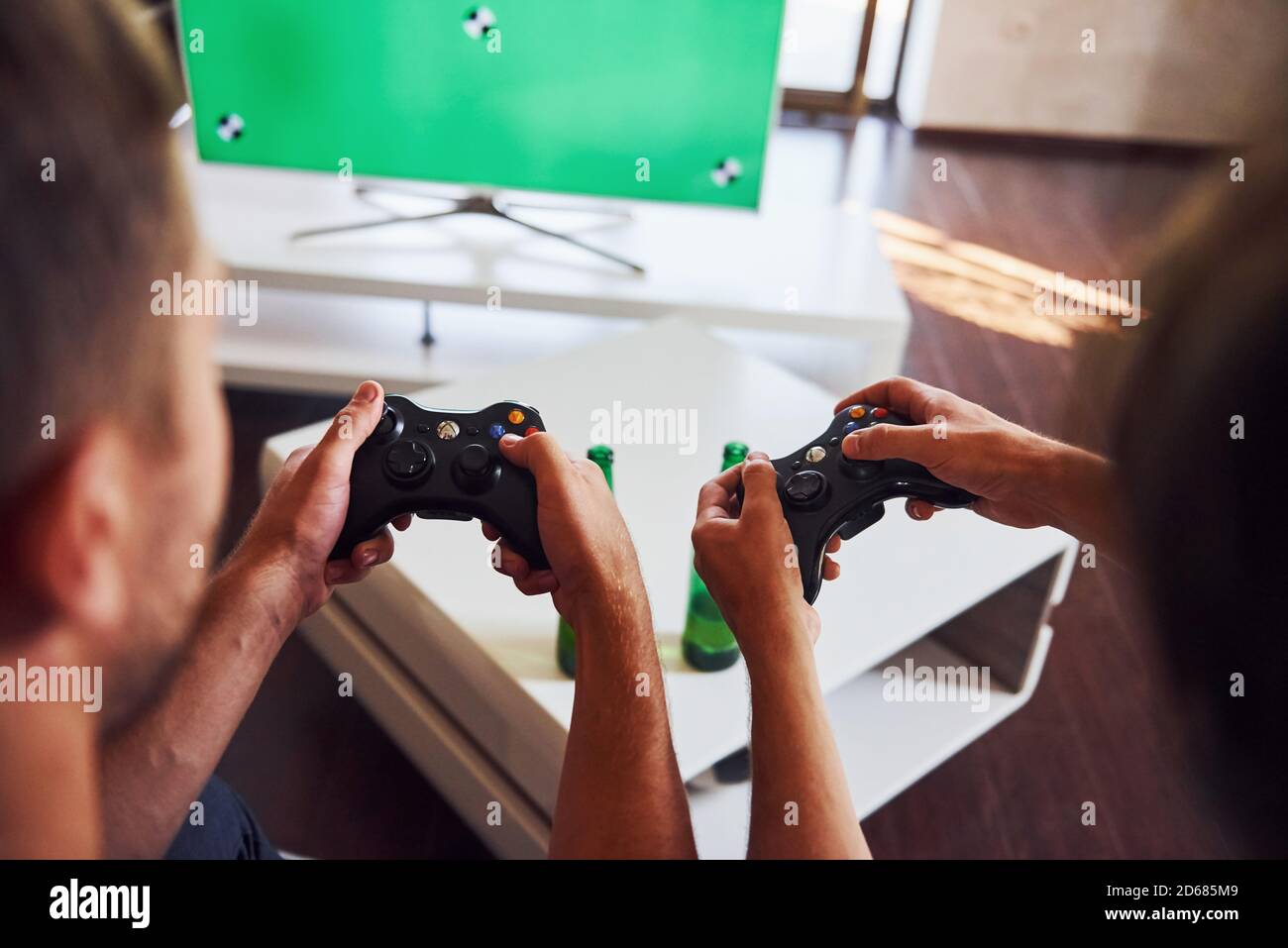 Group of friends have fun playing console game indoors at living room ...